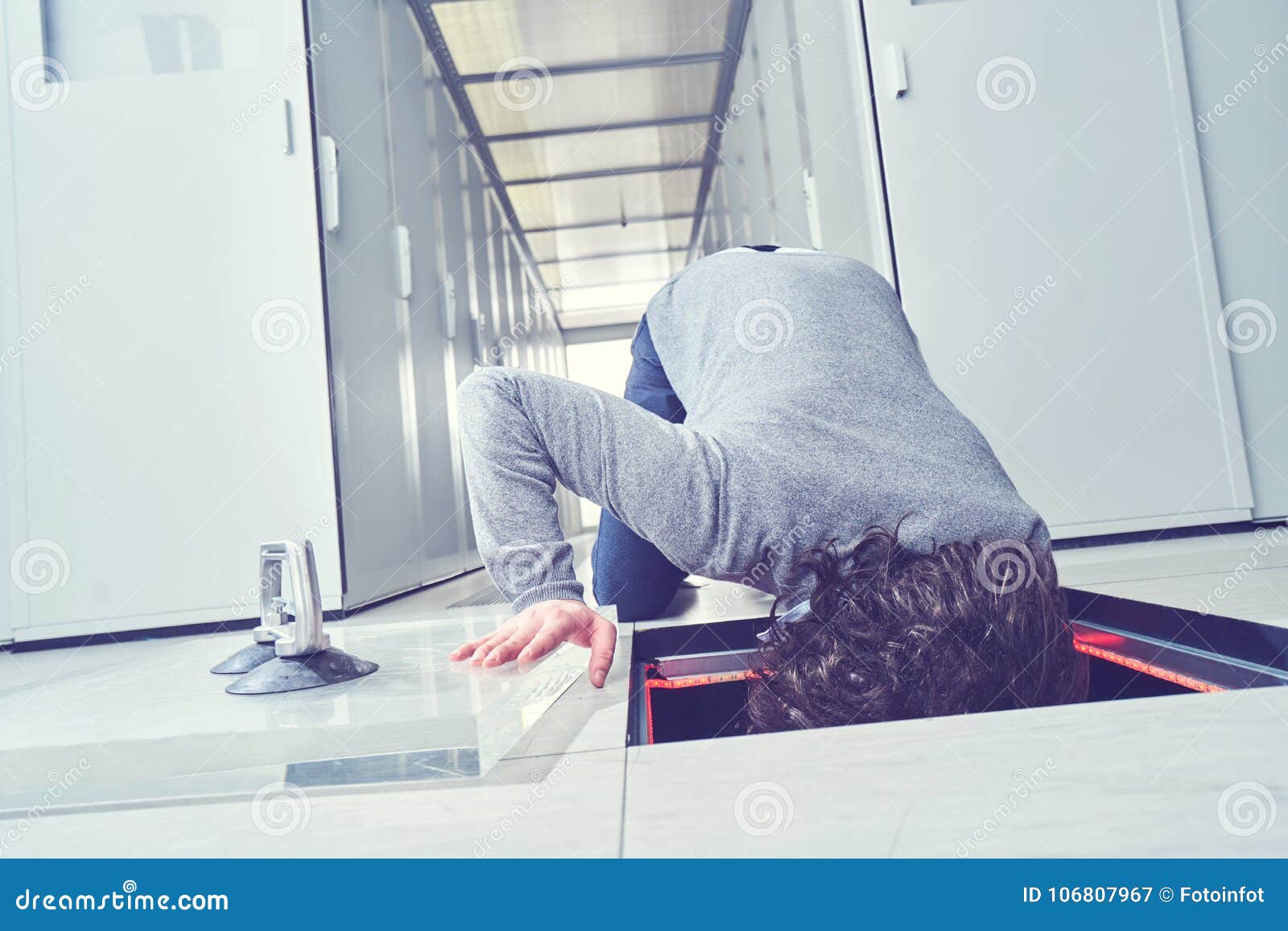 Young Man Fixing Something in the Floor Hatch. Data Center Stock Image ...