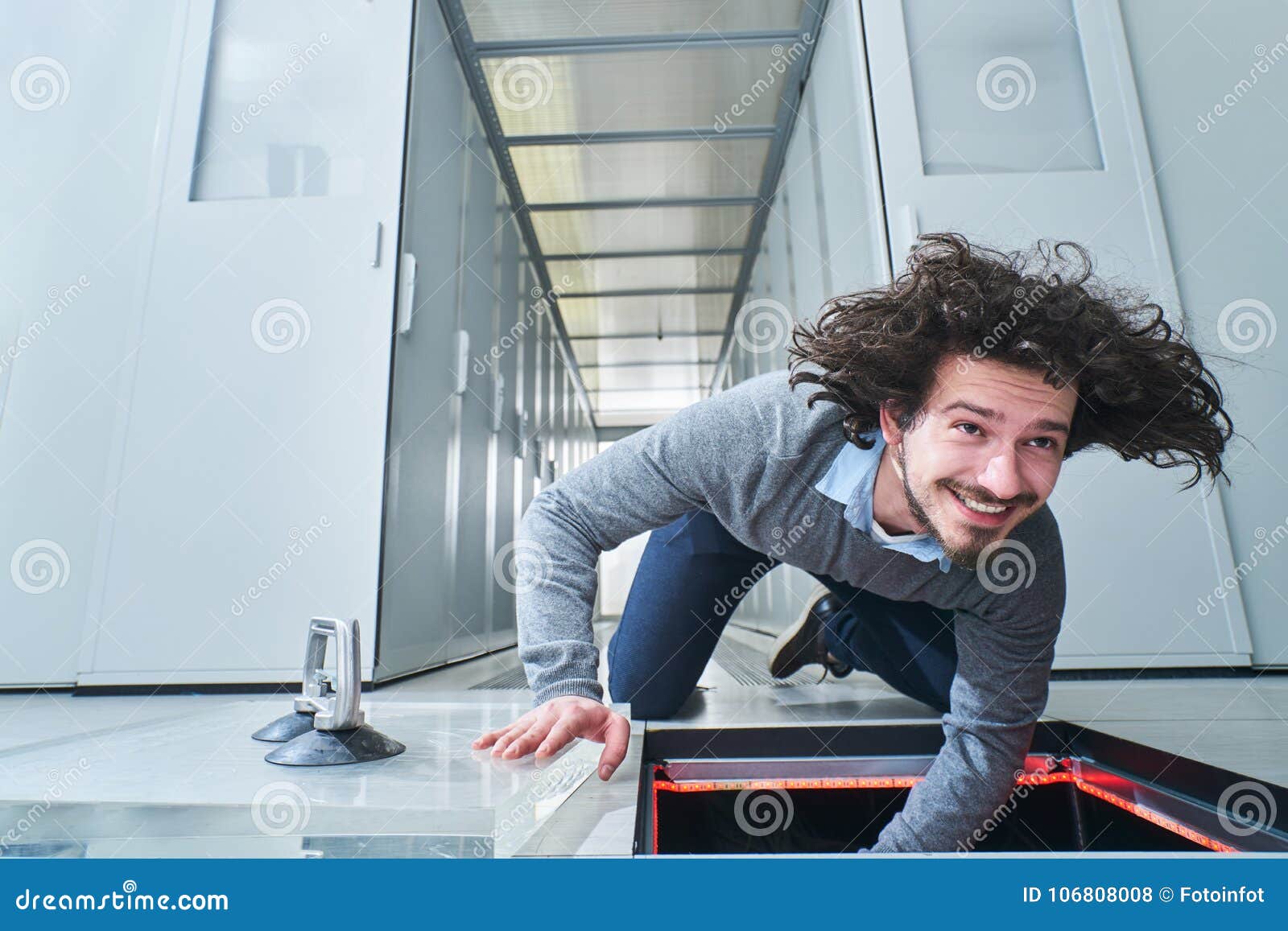 Young Man Fixing Something in the Floor Hatch. Data Center Stock Photo ...
