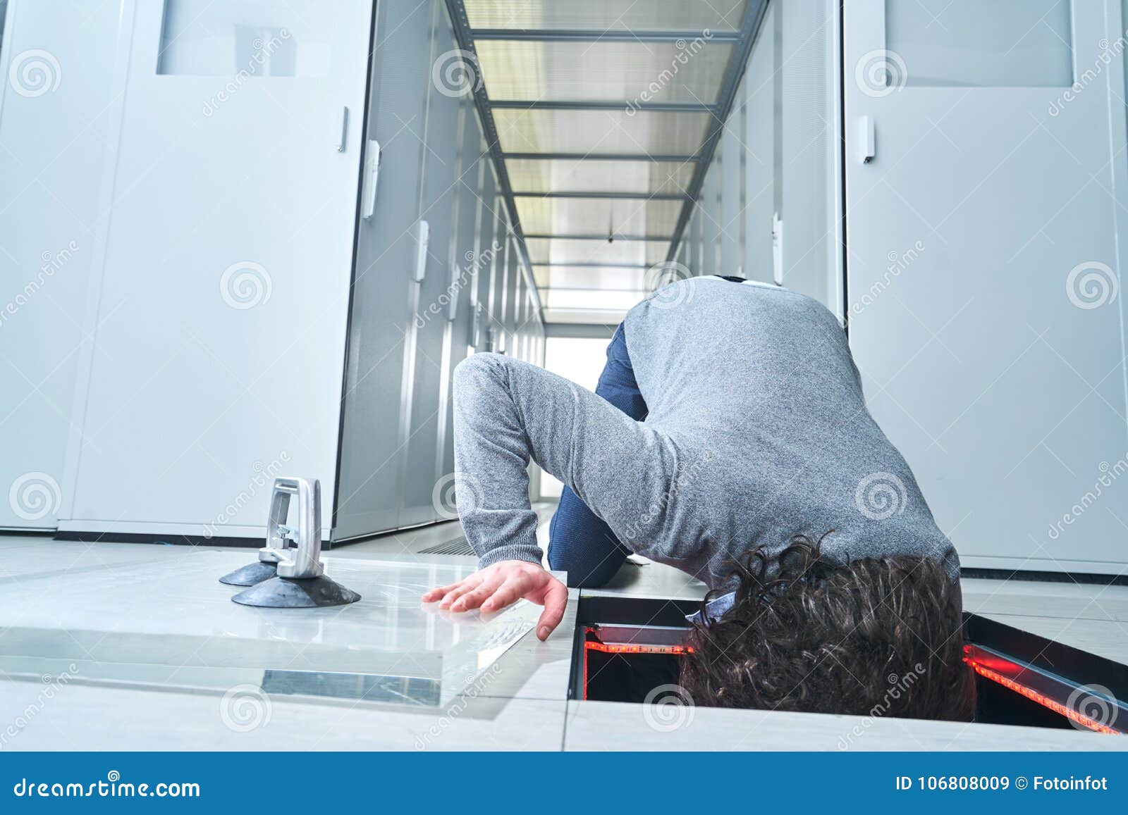 Young Man Fixing Something in the Floor Hatch. Data Center Stock Image ...