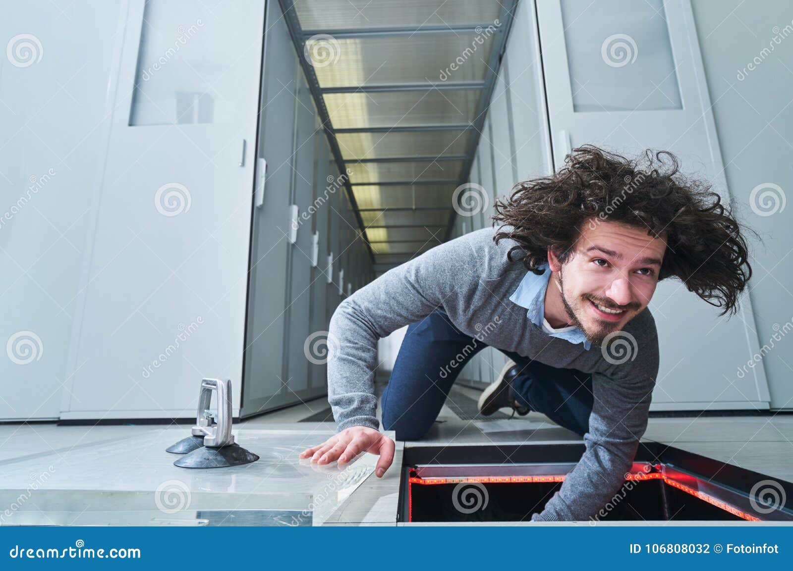Young Man Fixing Something in the Floor Hatch. Data Center Stock Photo ...