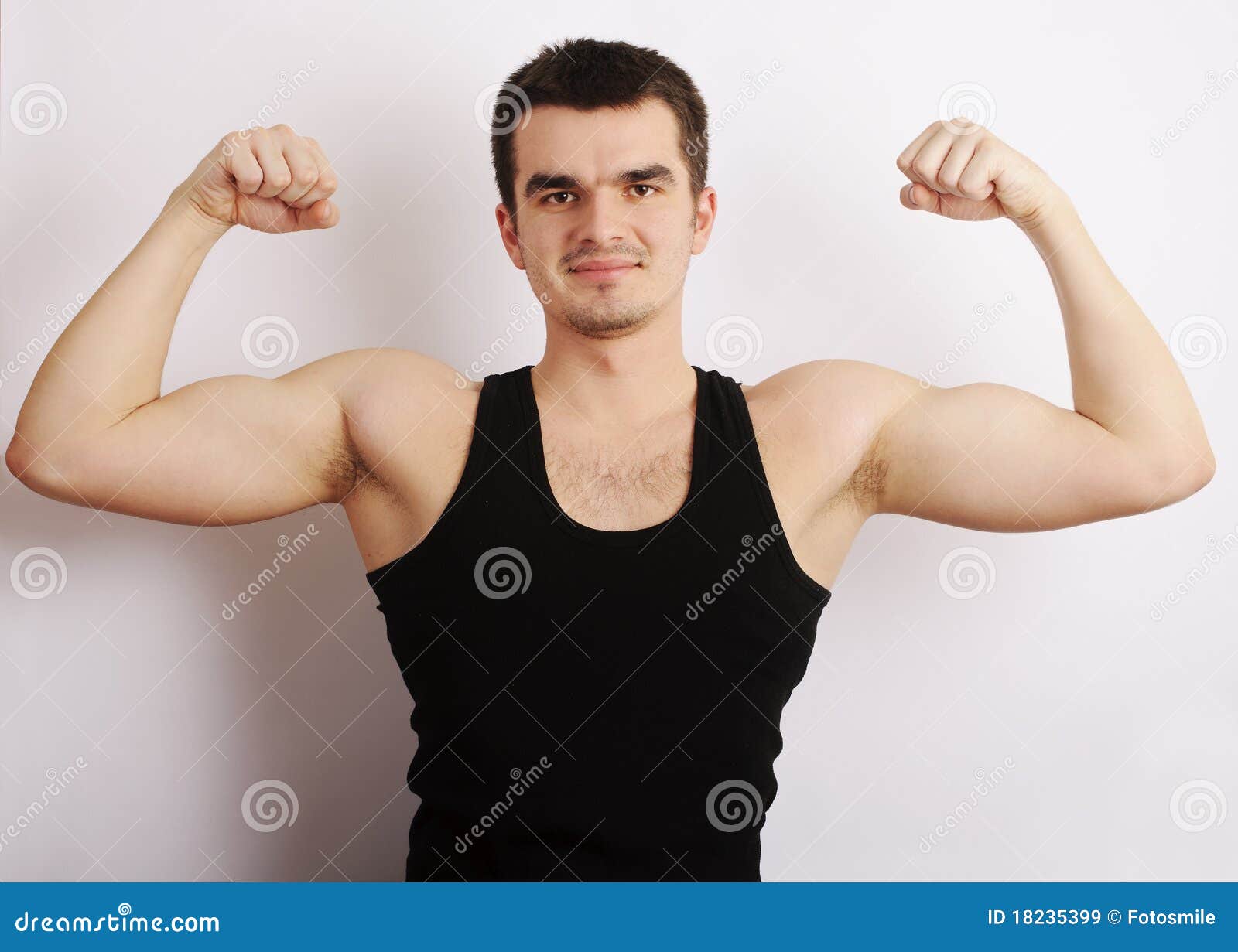 Portrait Of A Muscular Young Man Flexing Muscles Stock