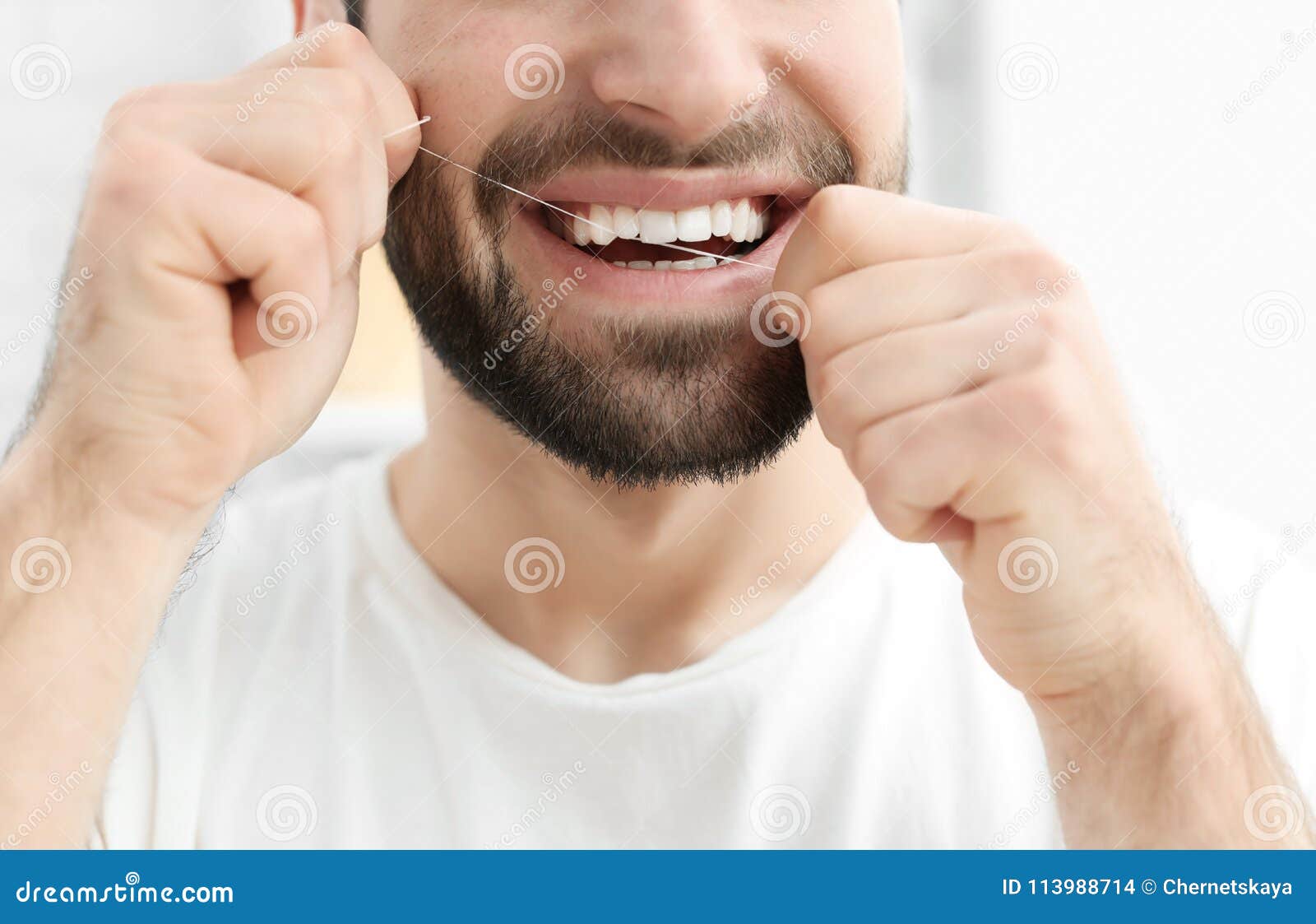 Young Man Flossing His Teeth Stock Photo - Image of dent, dental: 113988714