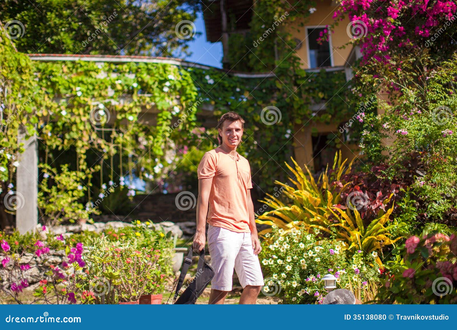 Young Man in a Flower Garden at the Exotic Resort Stock Photo - Image ...