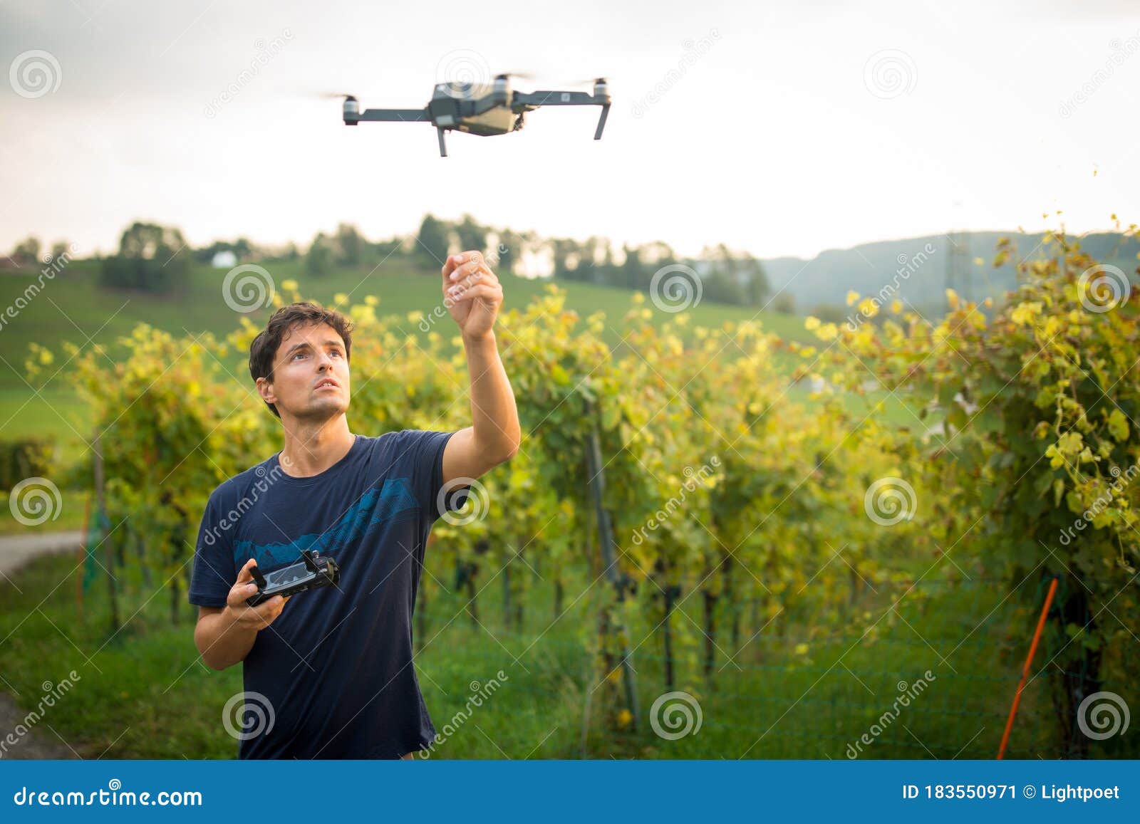 Young man flying a drone stock image. Image of beach - 183550971