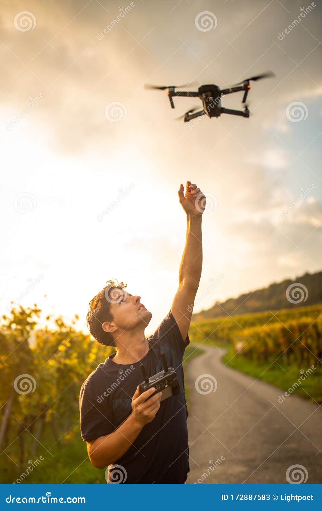 Young man flying a drone stock image. Image of shore - 172887583