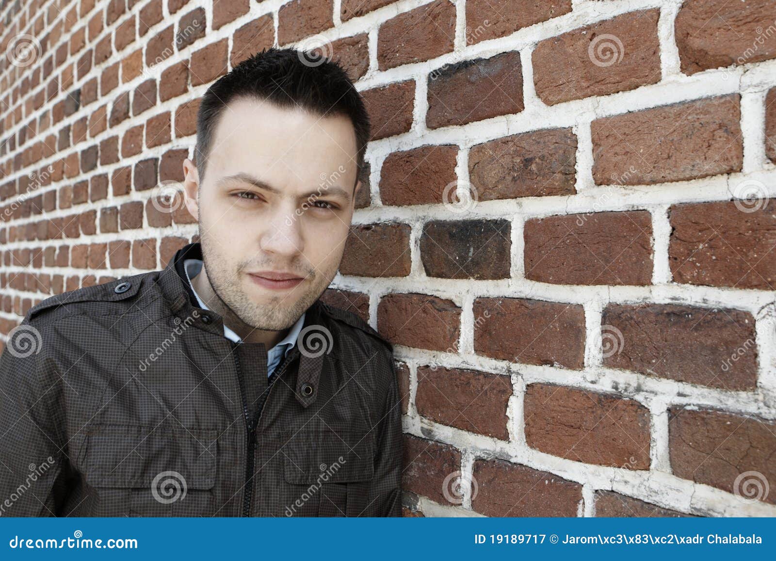 Young Man in Fron of the Brick Wall Stock Image - Image of casual ...