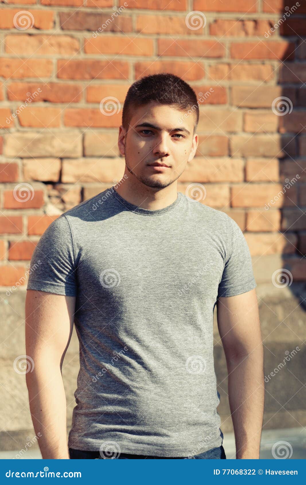 Young Man in Front of Brick Wall Stock Photo - Image of brick, muscular ...