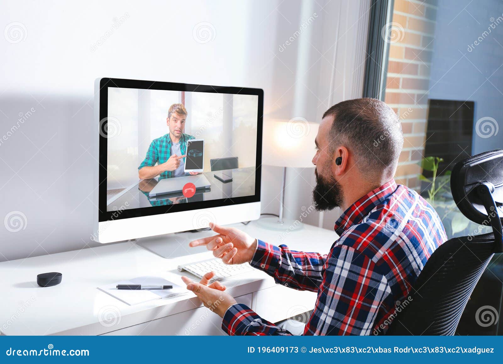Young Man in Front of Computer Having Video Conference with Coworker ...