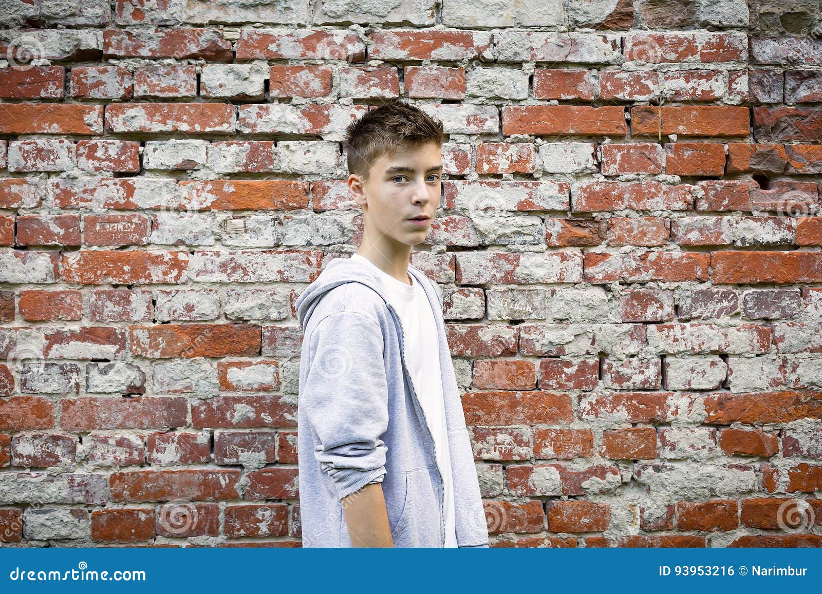 Young Man in Front of a Red Brick Wall Stock Photo - Image of smile ...