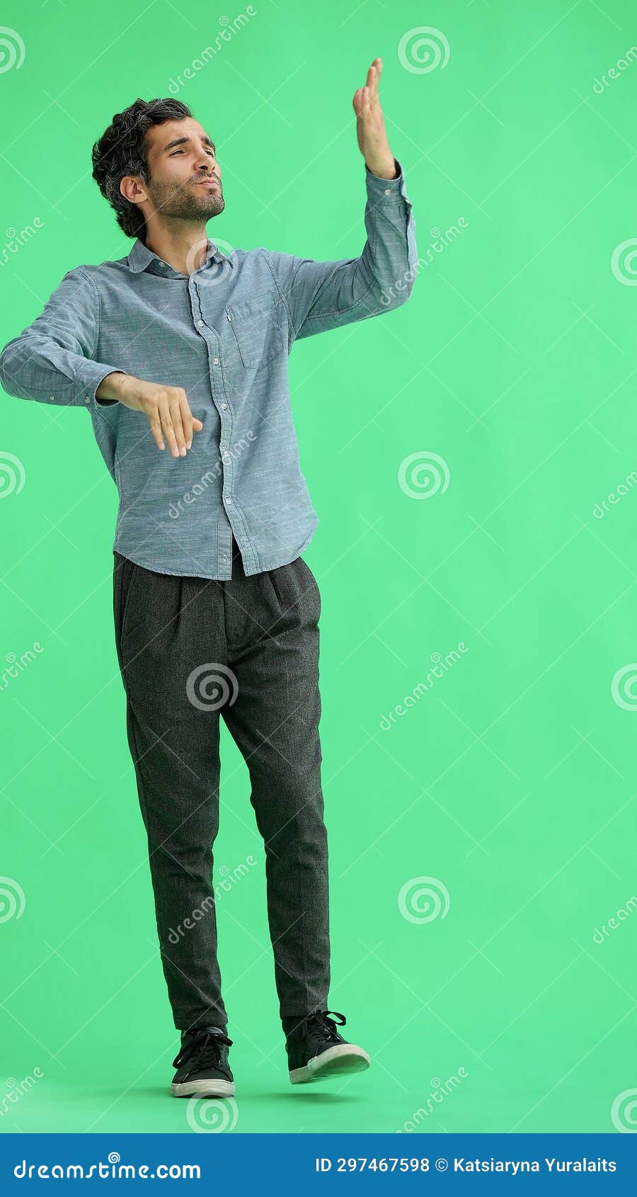 Young Man in Full Growth. Isolated on Green Background Shows Hand Wait ...