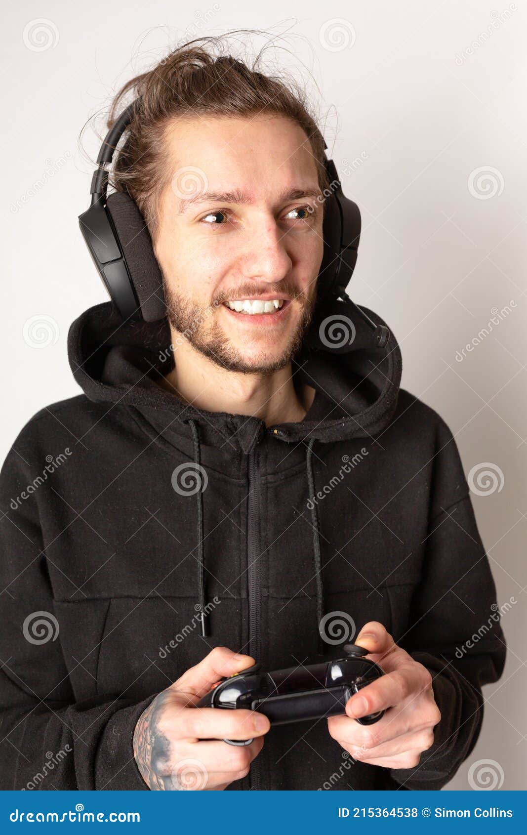 Young Man with a Gaming Headset and Controller Having Fun Playing a ...