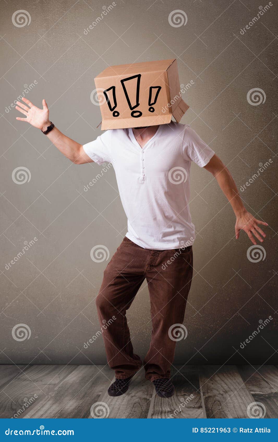 Young Man Gesturing with a Cardboard Box on His Head with Exclamation ...