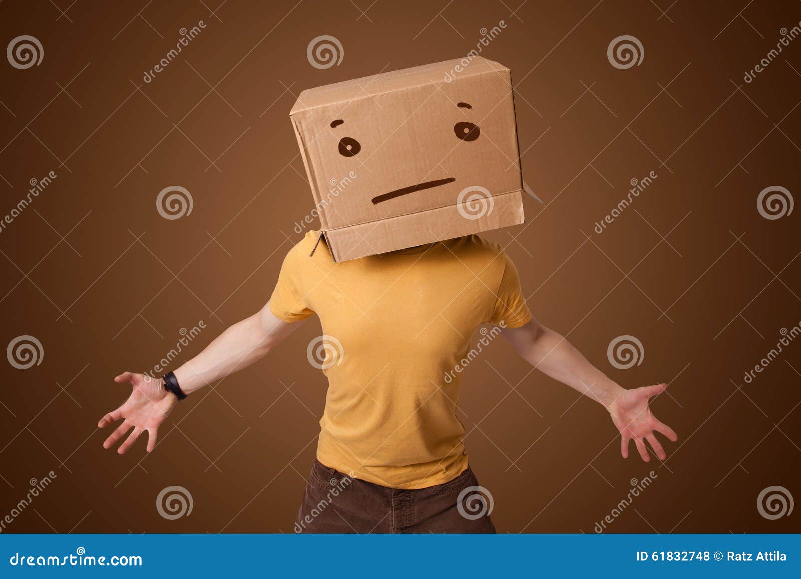 Young Man Gesturing with a Cardboard Box on His Head with Straight Face ...