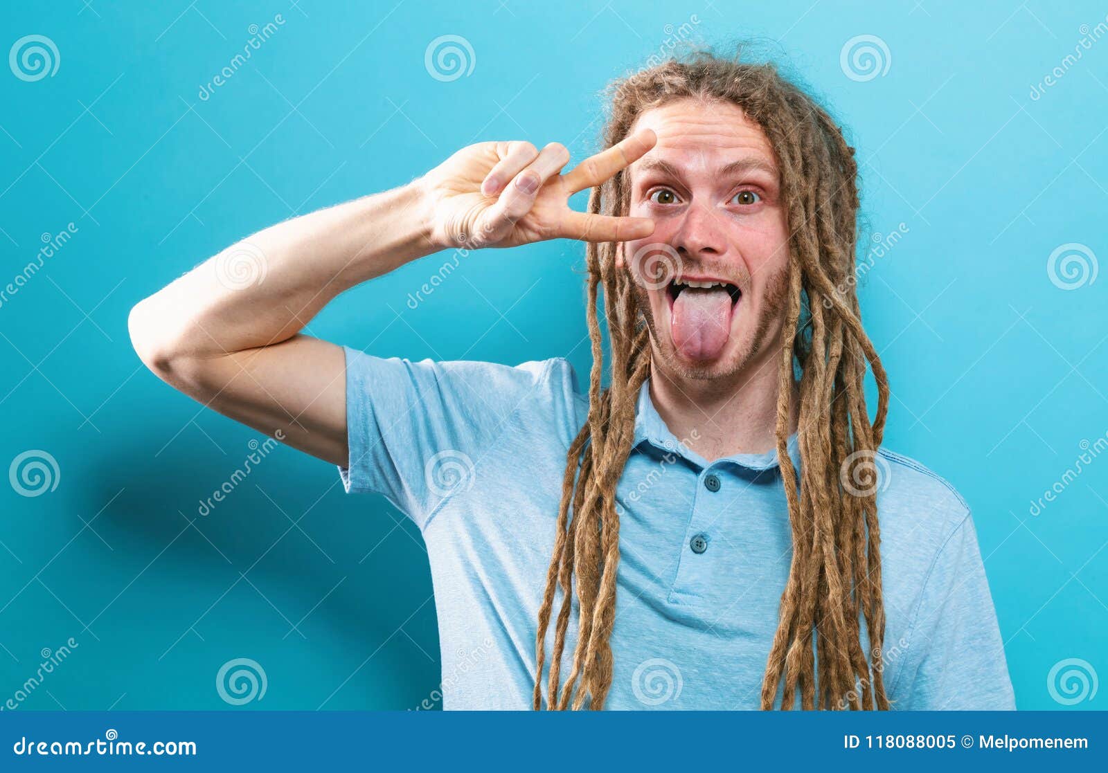 Young Man Giving the Peace Sign Stock Image - Image of blue, solid ...