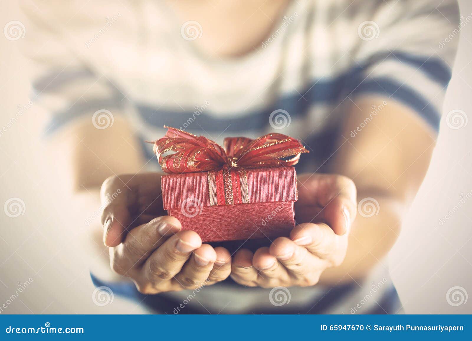 Young Man Giving and Presenting a Gift To Someone. Stock Photo - Image ...