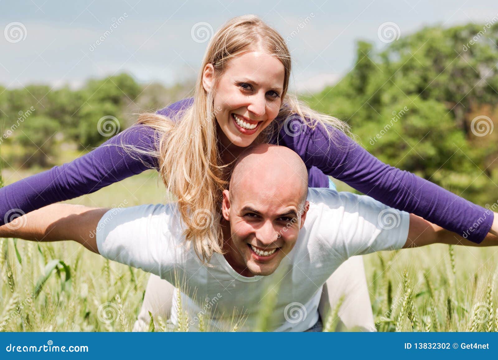 Young Man Giving Shoulder Ride To Her Girlfriend Stock Photo - Image of ...