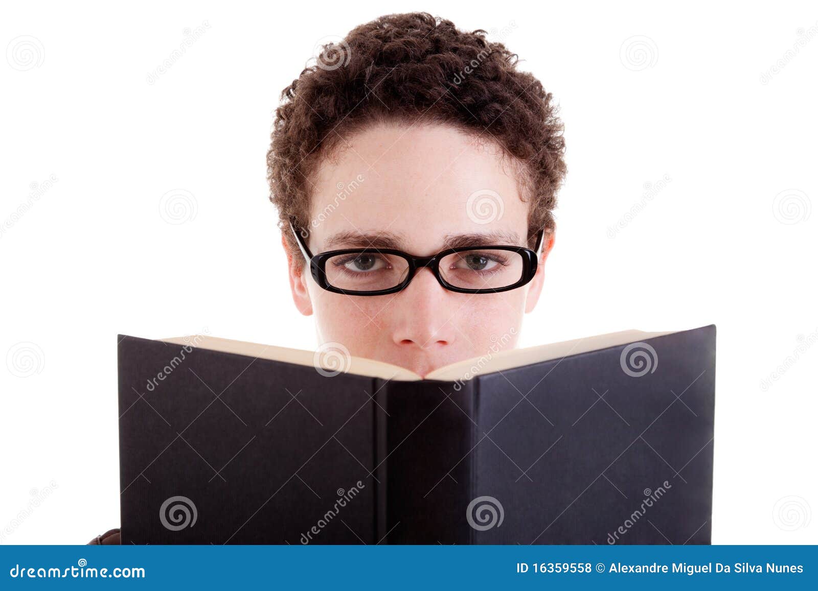 Young Man with Glasses, Peering Over an Open Book Stock Photo - Image ...