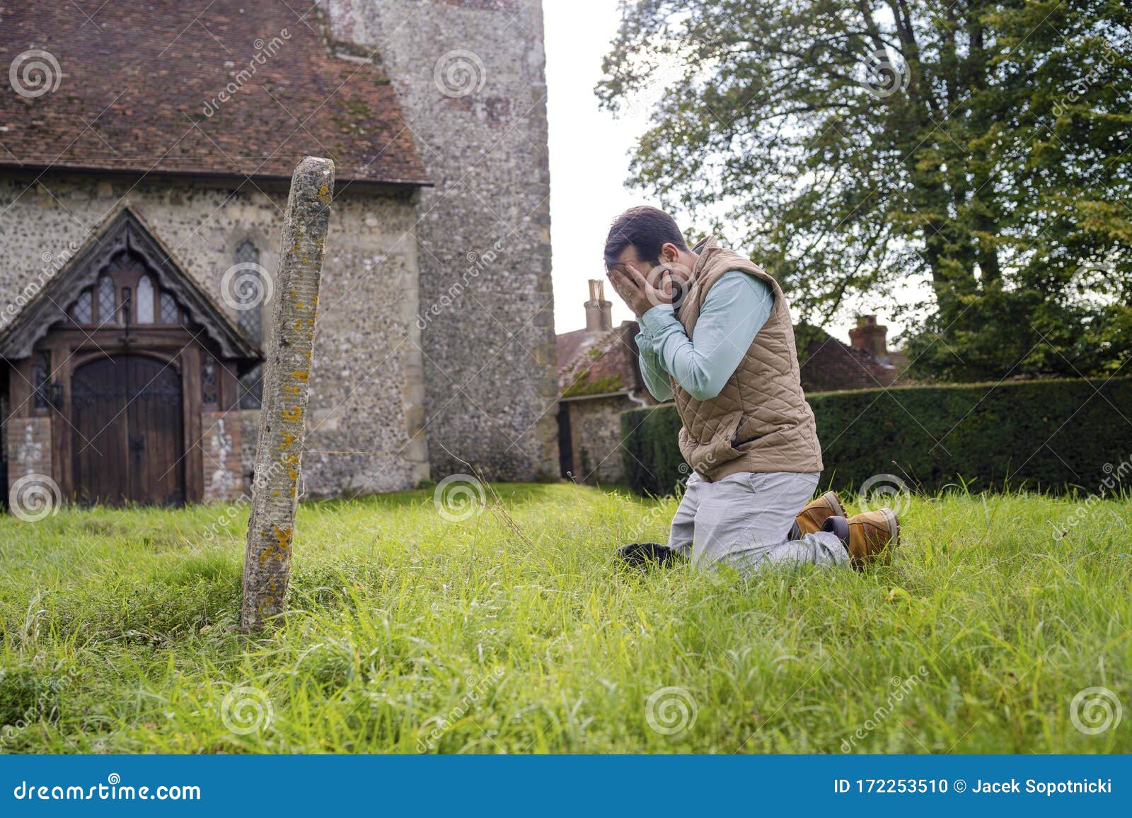 A Young Man Grieving in the Old Graveyard Stock Photo - Image of ...
