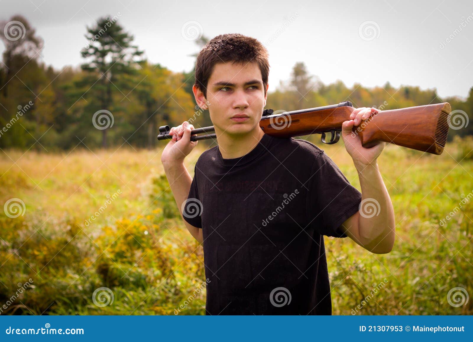 Young man with gun stock image. Image of handsome, back - 21307953