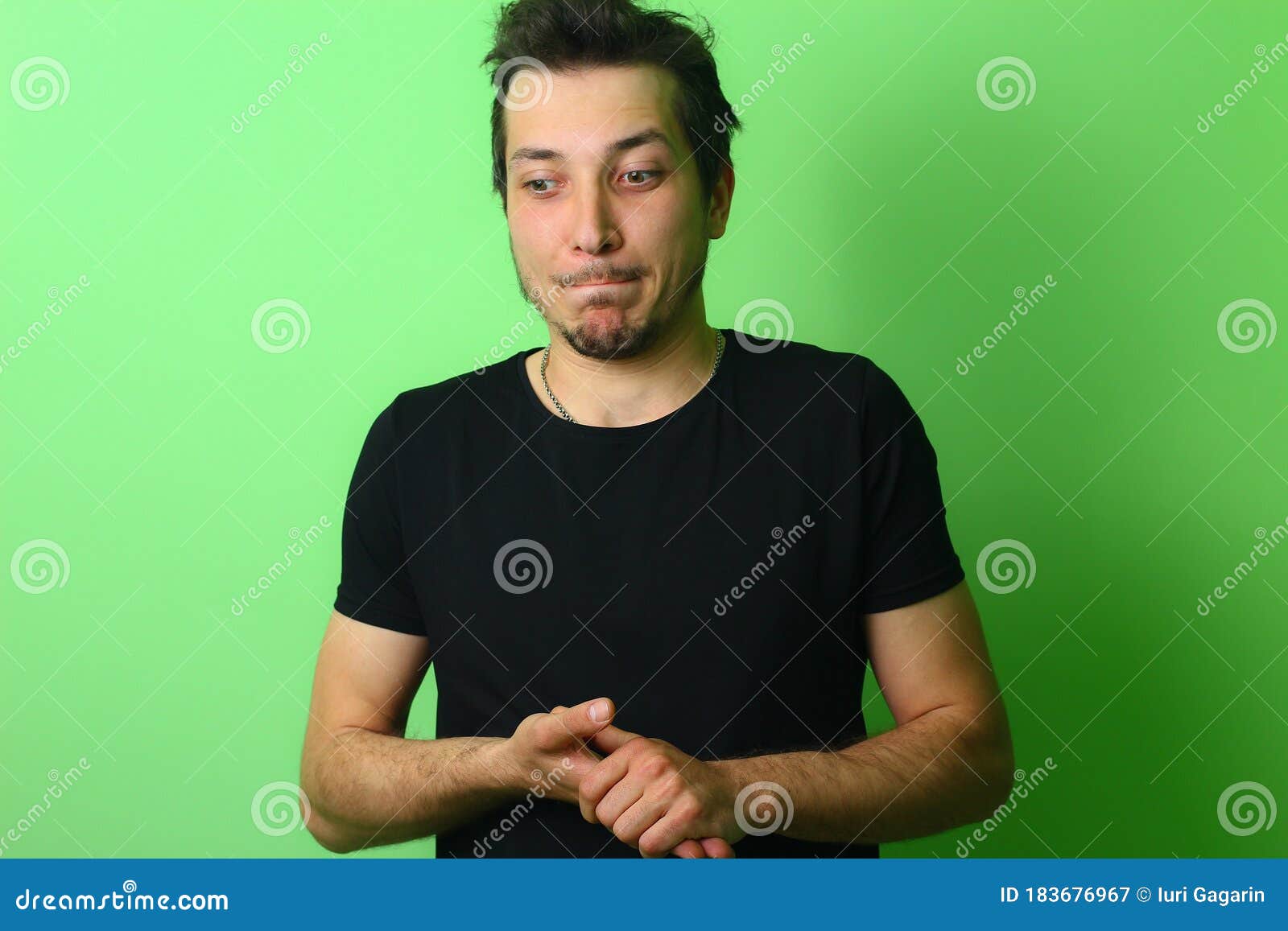 Young Man or Guy on a Light Green Wall Background. Emotion of Guilt ...