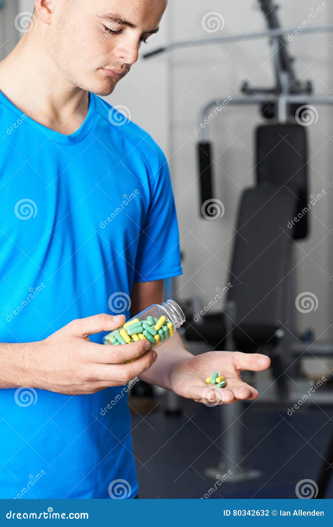 Young Man in Gym Taking Tablets Stock Photo - Image of building ...
