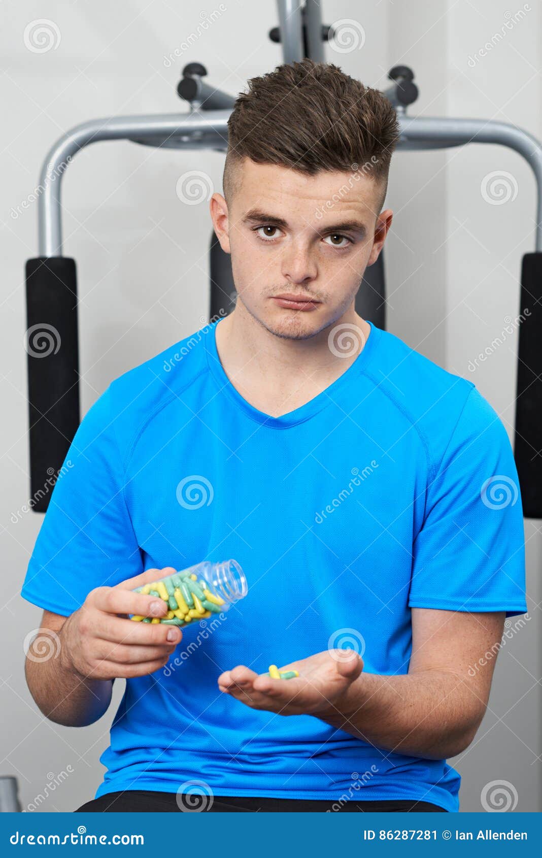 Young Man in Gym Taking Tablets Stock Image - Image of medicine, tablet ...