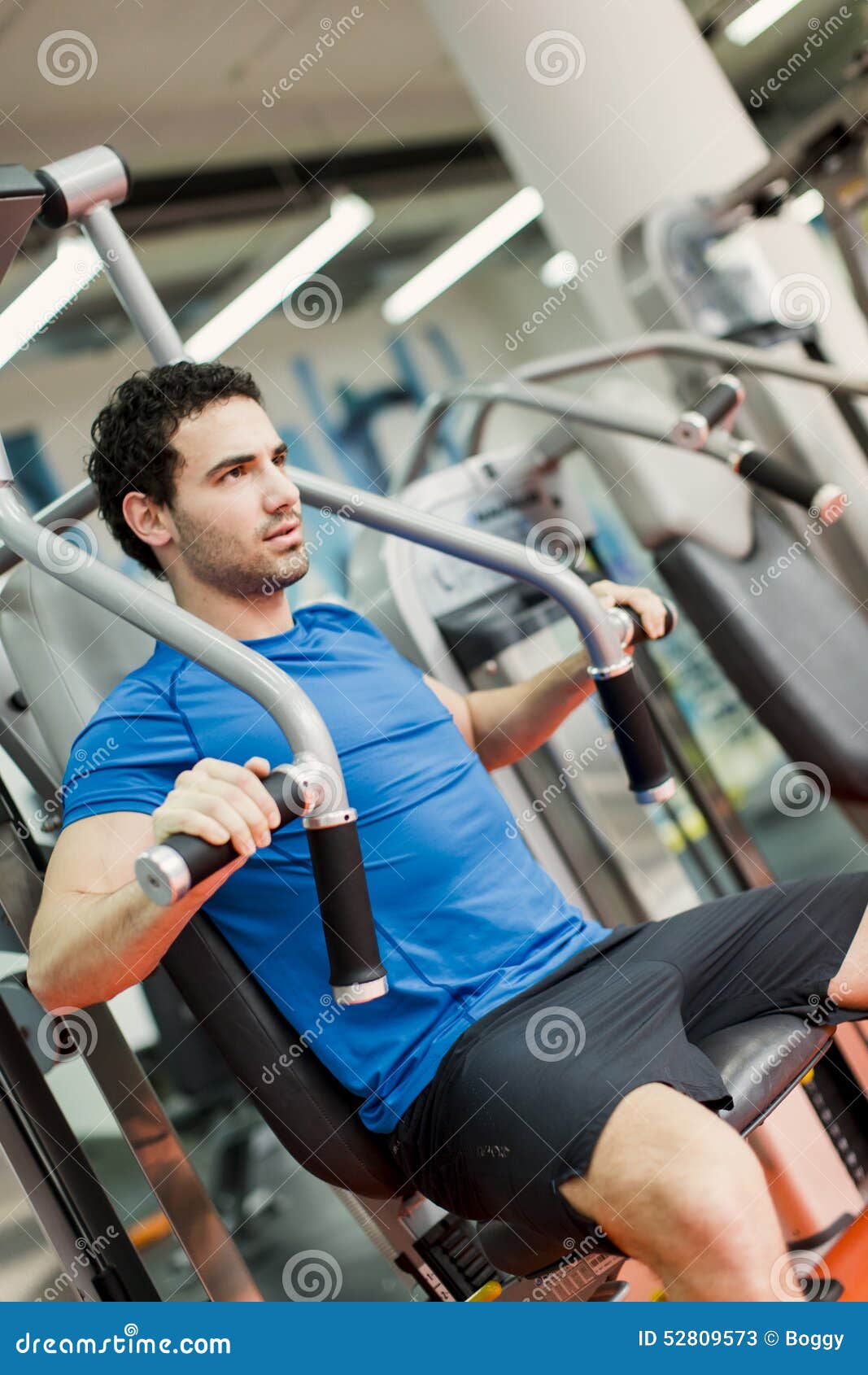 Young man in the gym stock image. Image of muscular, apparatus - 52809573