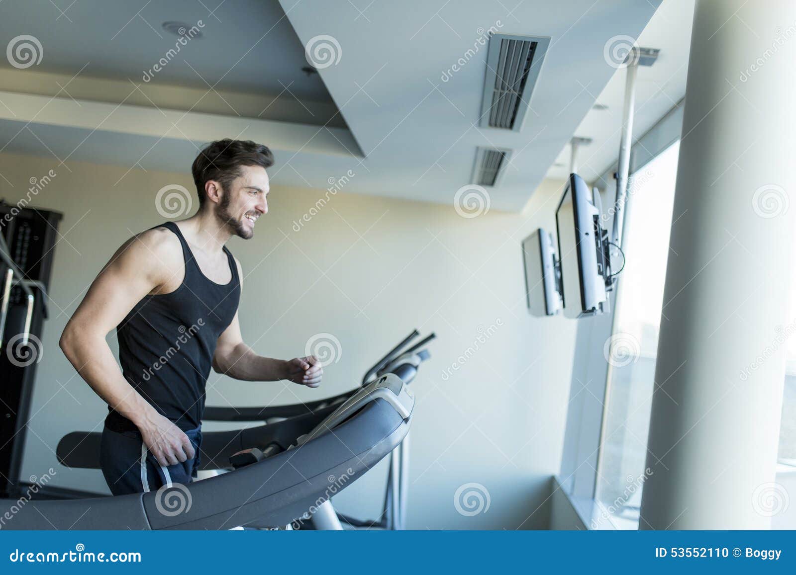 Young man in the gym stock photo. Image of treadmill - 53552110