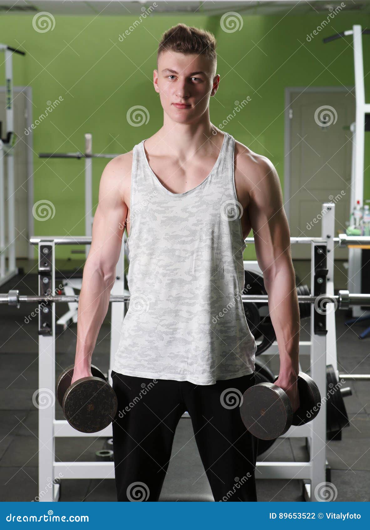 The young man in the gym stock photo. Image of fitness - 89653522