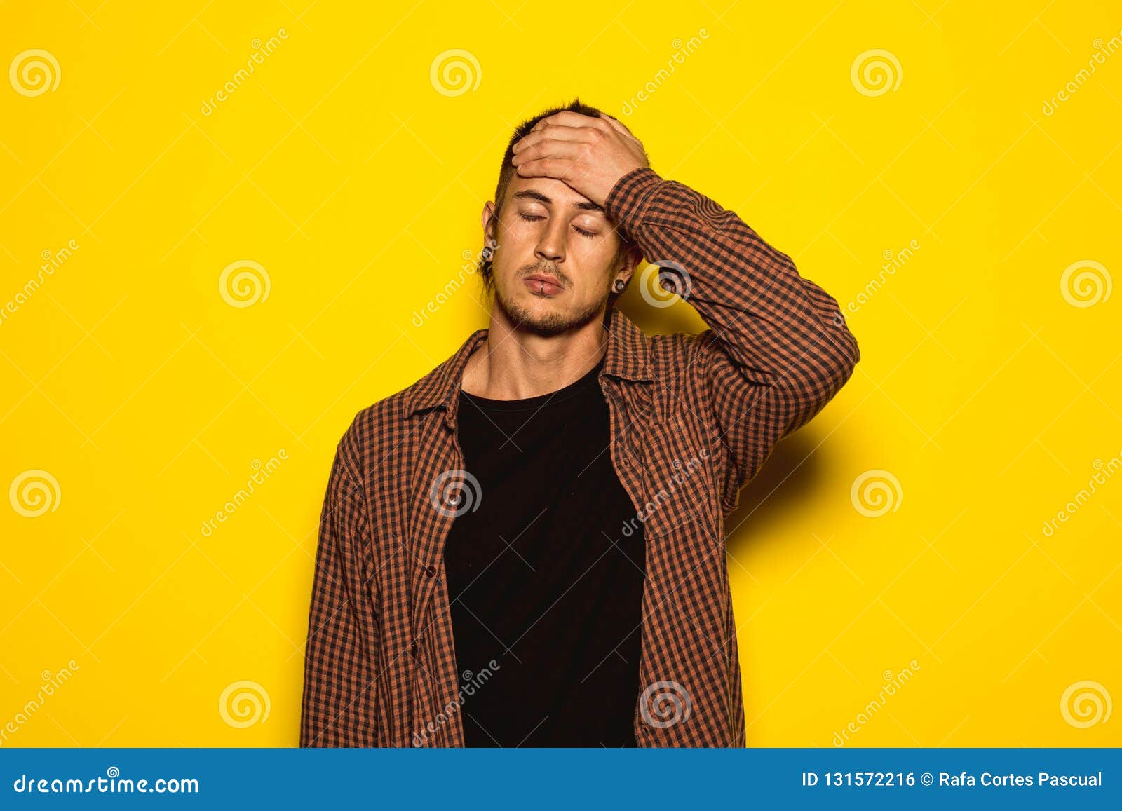 Young Man with Hand on Forehead Stock Photo - Image of beard, portrait ...