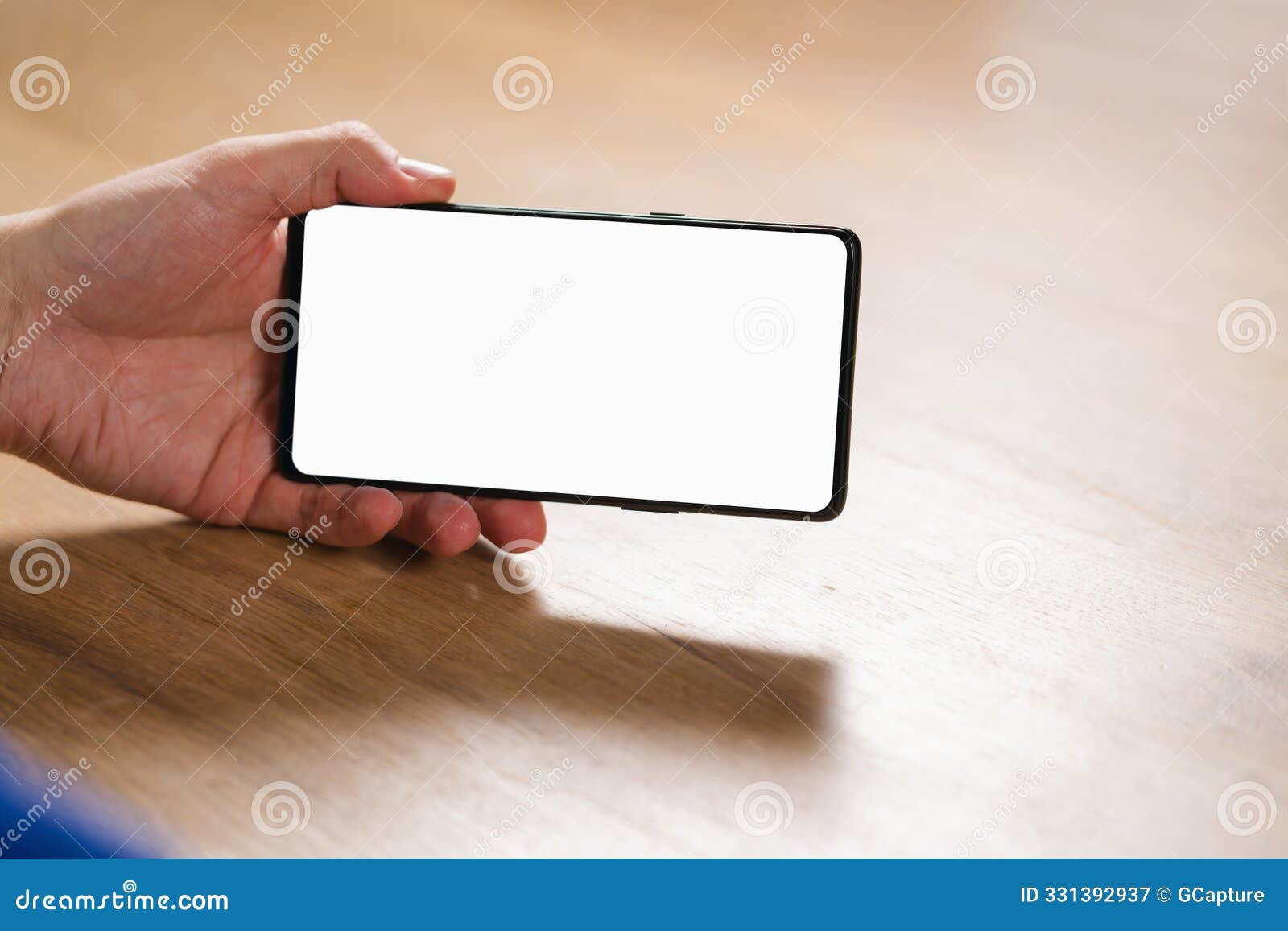Young Man Hand Holding Smartphone with Blank White Screen in Landscape ...