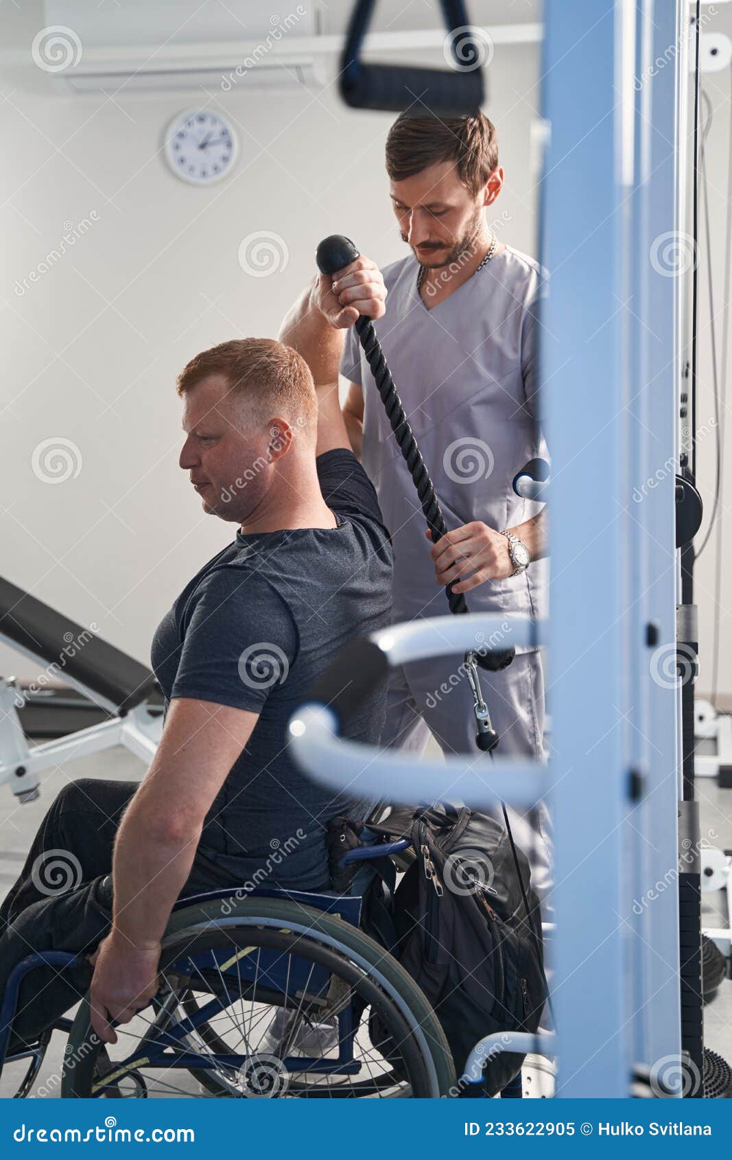 Young Man with Handicap Doing Weight Training Exercises, Pulls Cable ...