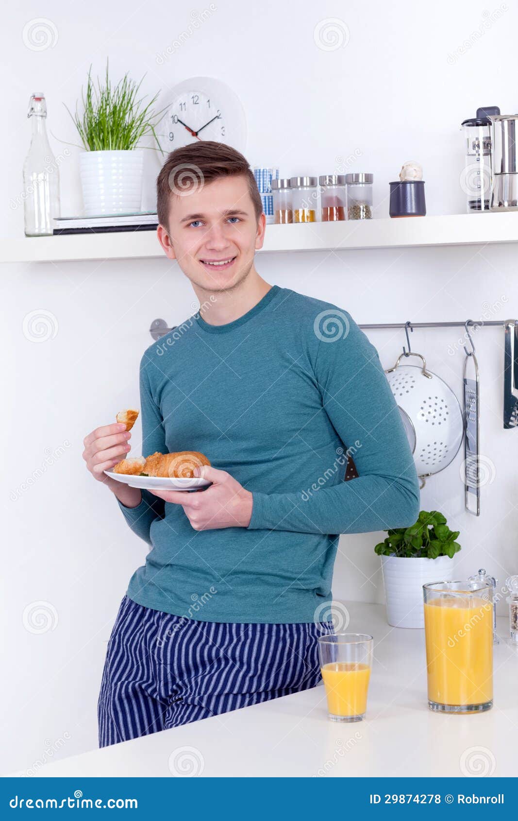Young Man Having Breakfast in His Kitchen Stock Photo - Image of orange ...