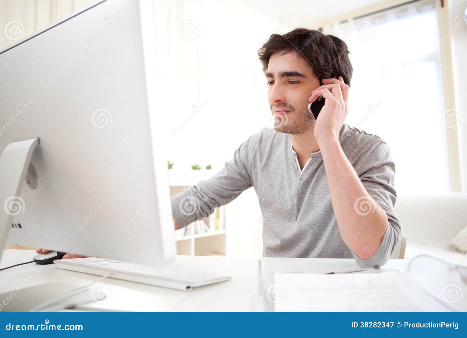 Young Man Having a Call in Front of Computer Stock Image - Image of ...