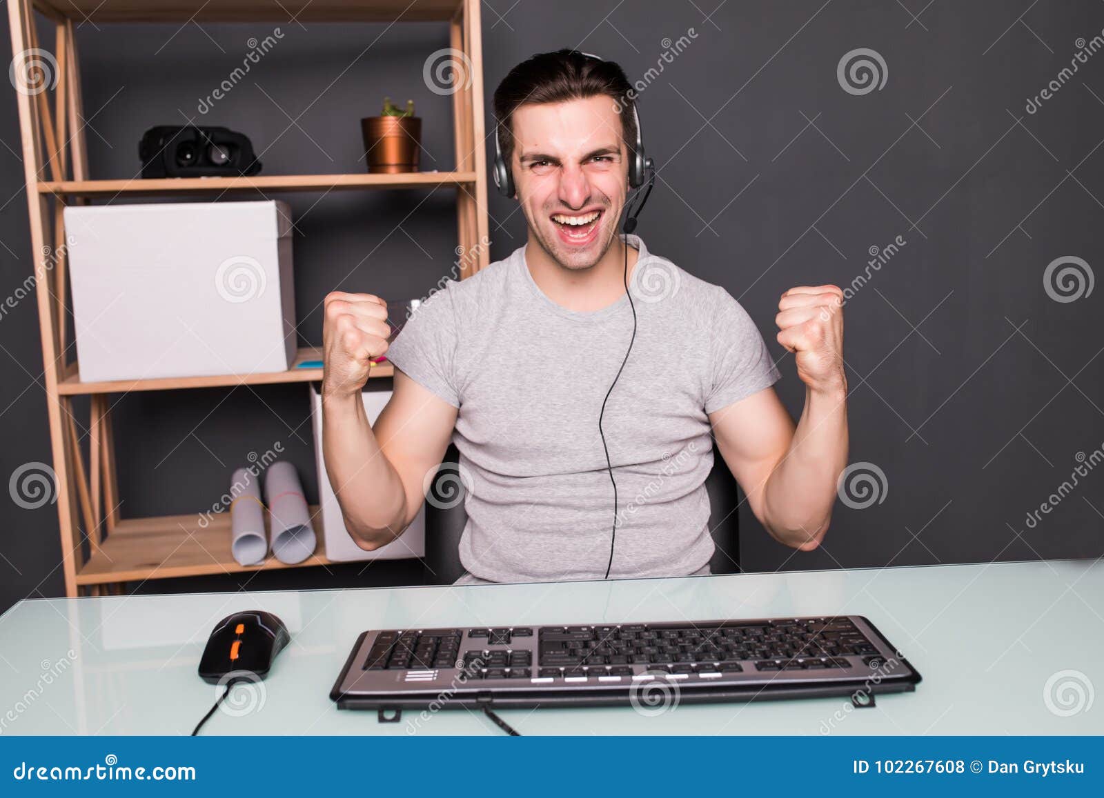 Young Happy Man with Headset Playing and Winning Computer Game at Home ...