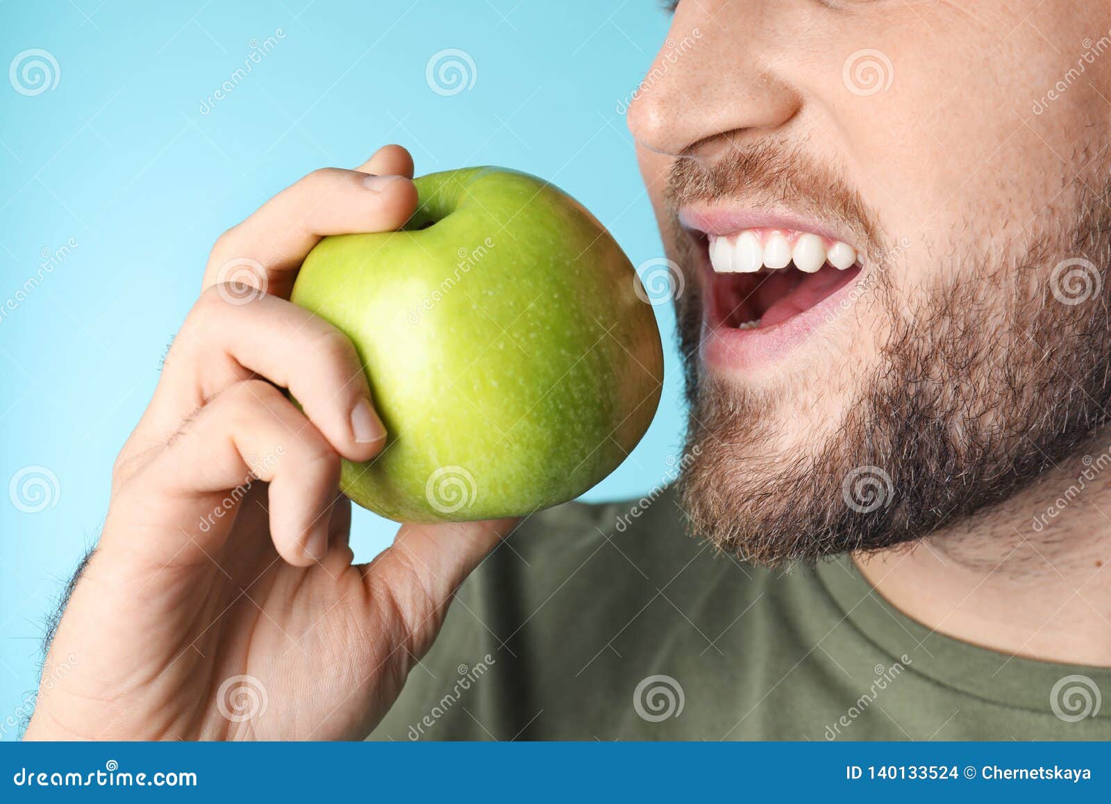 Young Man with Healthy Teeth and Apple on Color Background Stock Photo ...