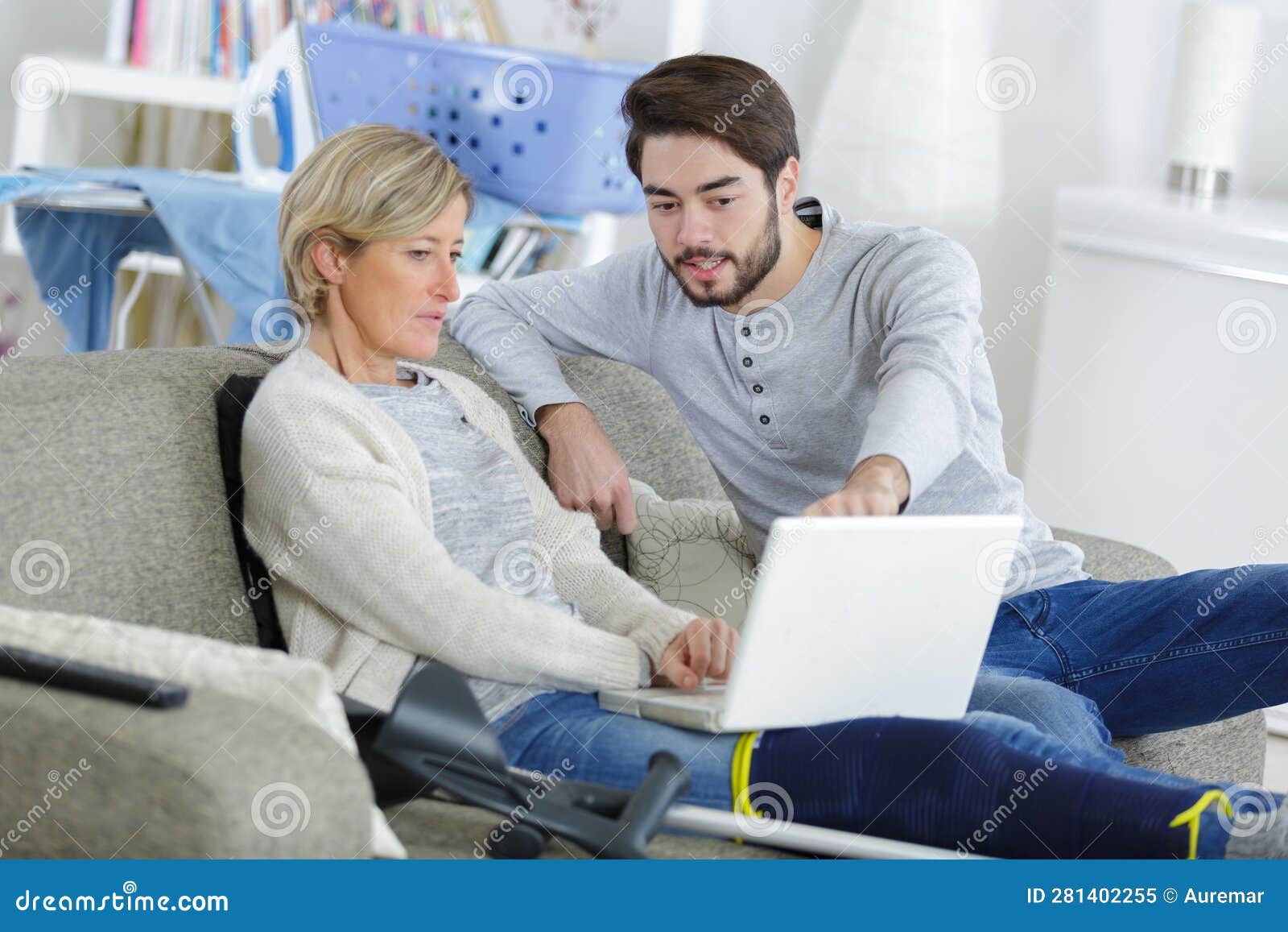 Young Man Helping Injured Woman on Computer Stock Image - Image of ...