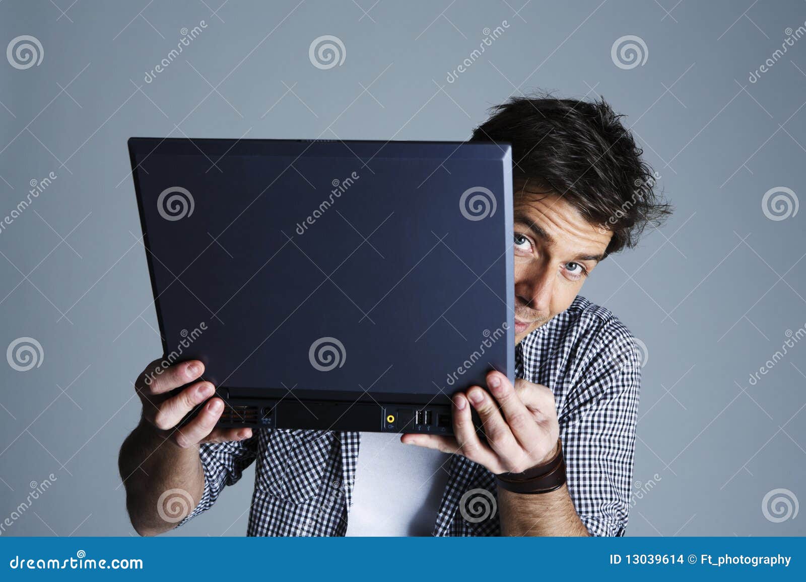 Young Man Hiding Behind Laptop Computer Stock Photo - Image of holding ...