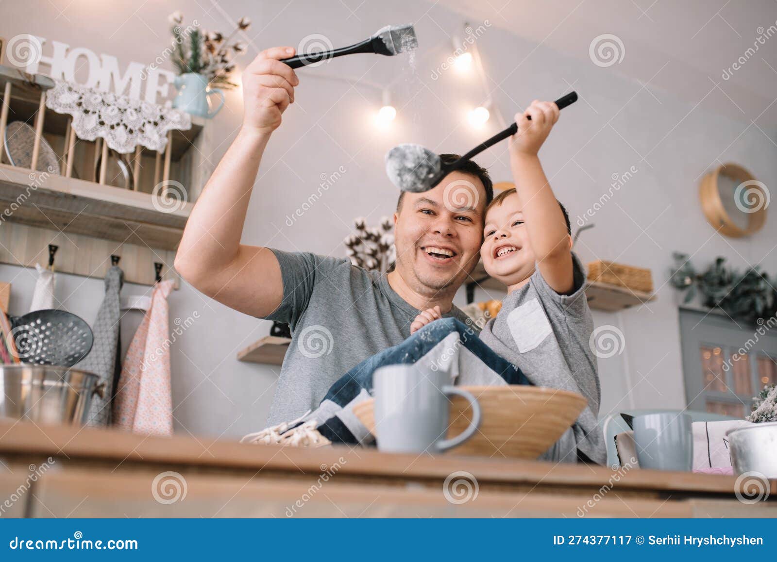 Young Man and His Son with Oven Sheet in Kitchen. Father with Little Son on the Kitchen. Stock ...
