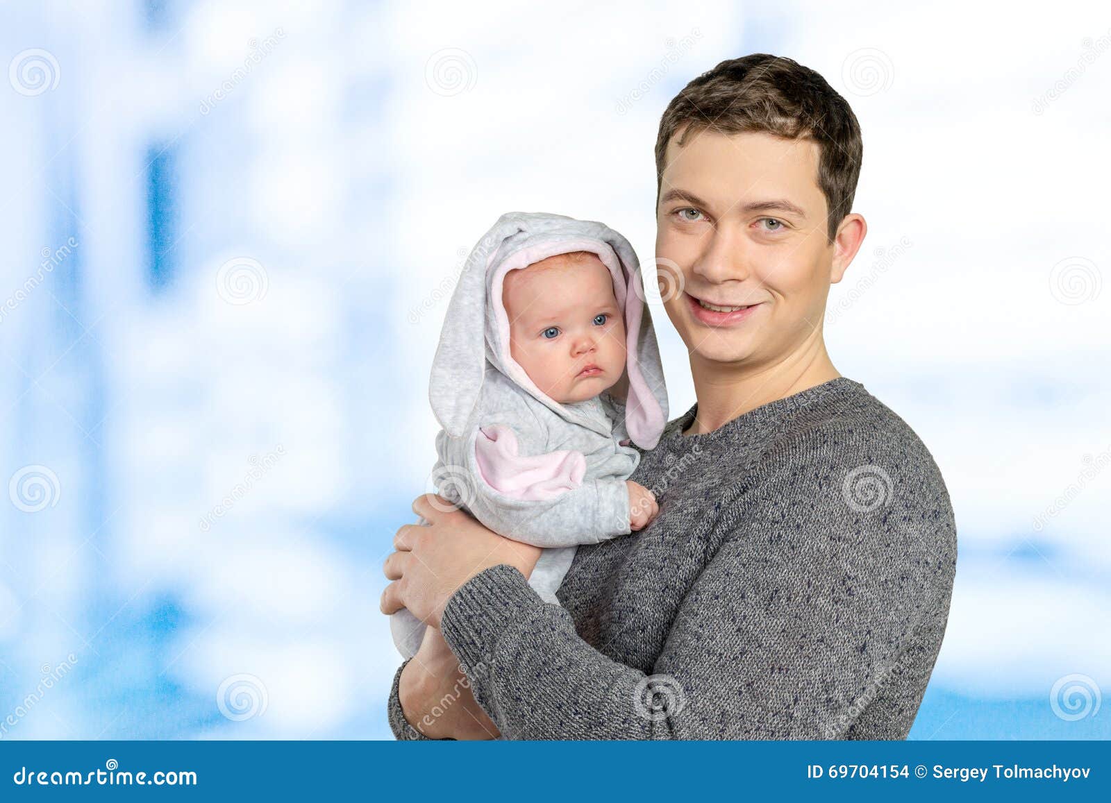 Young man holding a baby stock photo. Image of family - 69704154