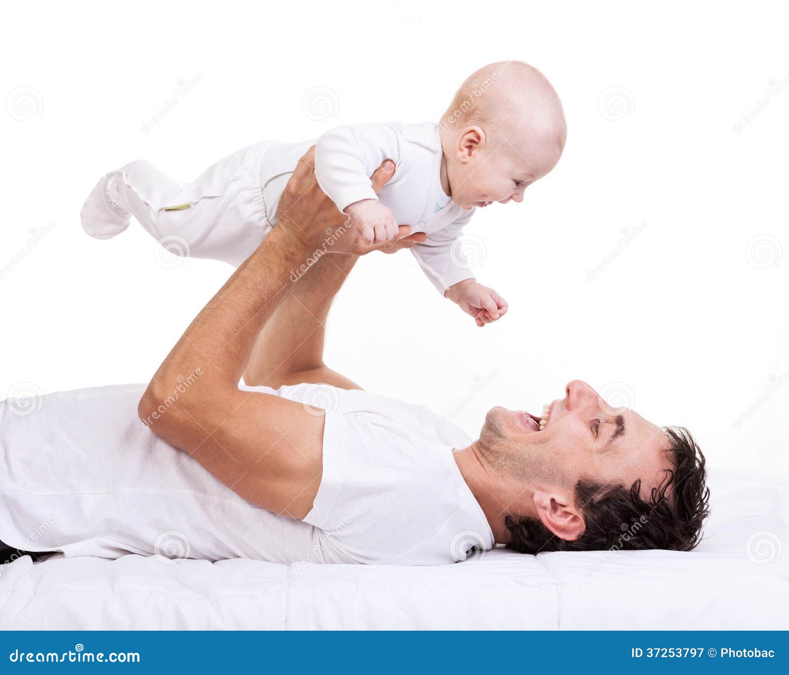 Young Man Holding Baby Son while Lying on Back Stock Image - Image of ...