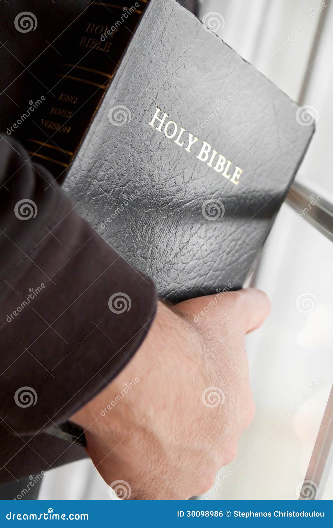 Young man holding Bible stock photo. Image of honor, hand - 30098986