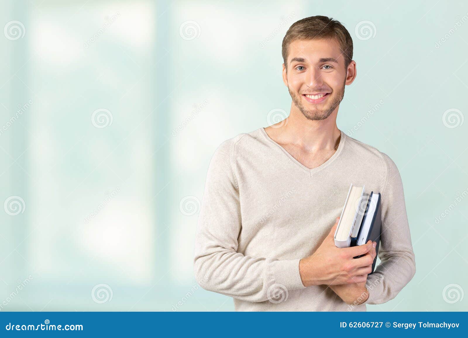 Young man holding books stock image. Image of happiness - 62606727