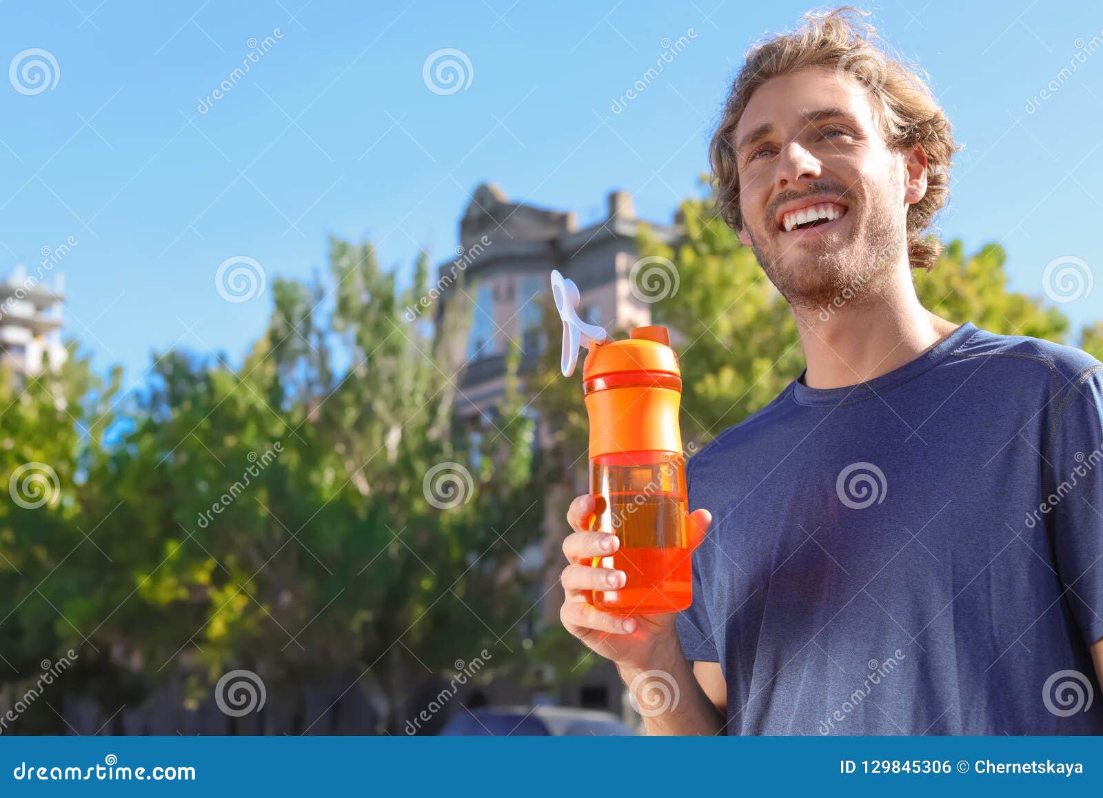 Young Man Holding Bottle with Clean Water Outdoors. Stock Photo - Image ...