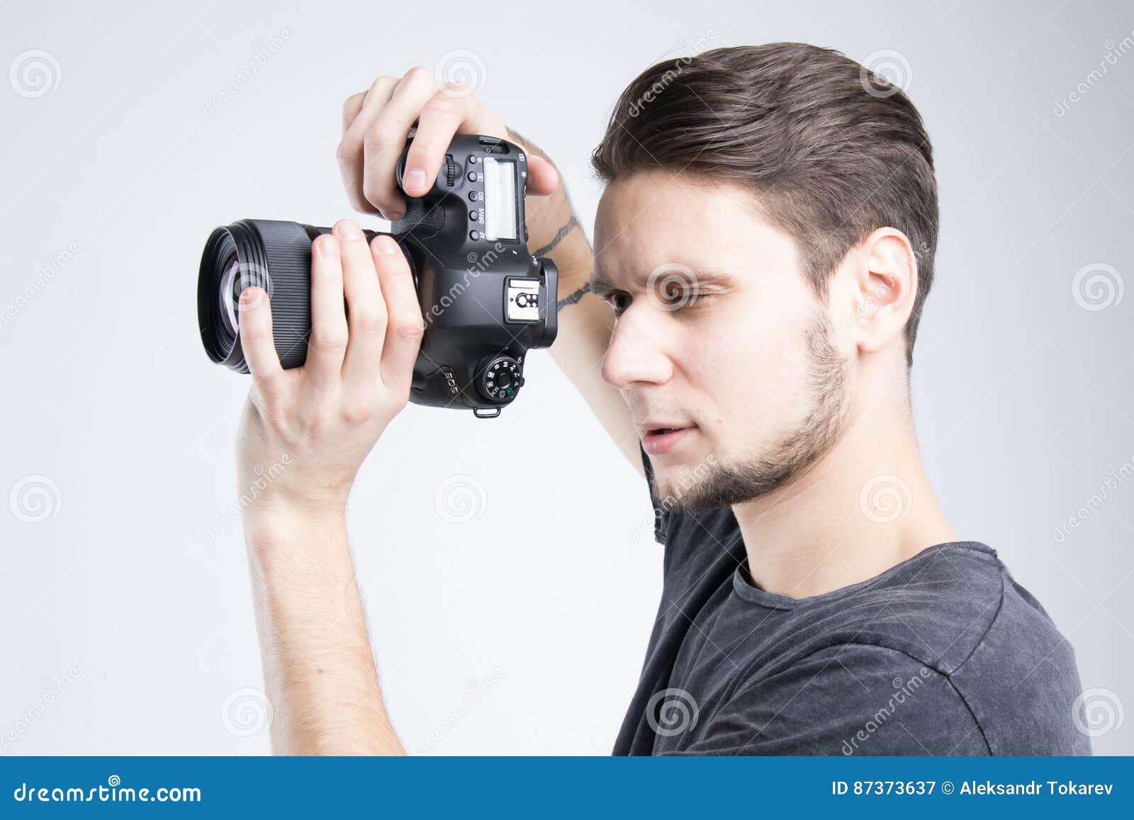 Young Man Holding Camera in Black Shirt Isolated Studio Stock Image ...