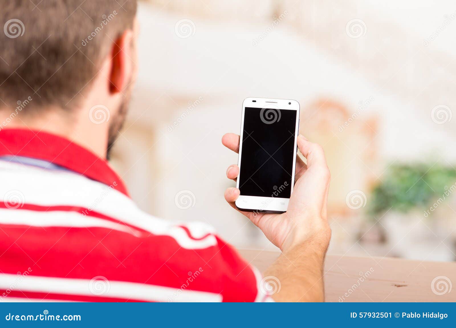 Young Man Holding Cellphone Stock Image - Image of outdoor, looking ...