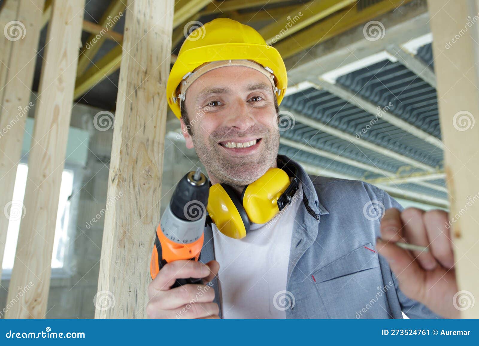 Young Man Holding Drill on Construction Site Stock Image - Image of ...