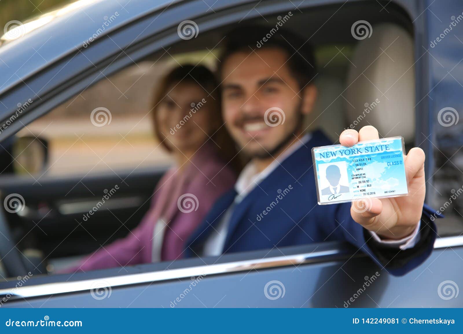 Young Man Holding Driving License in Car with Passenger Stock Image ...