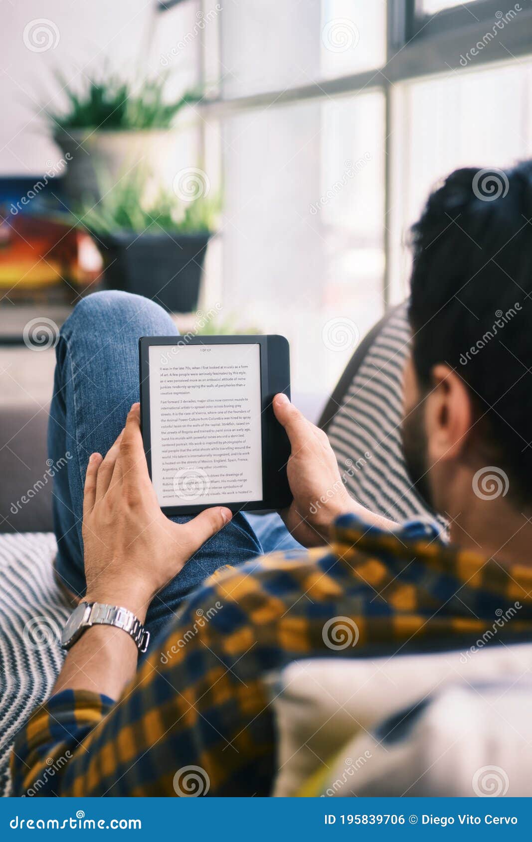 Young Man Holding Ereader and Reading Ebook Stock Photo - Image of home ...