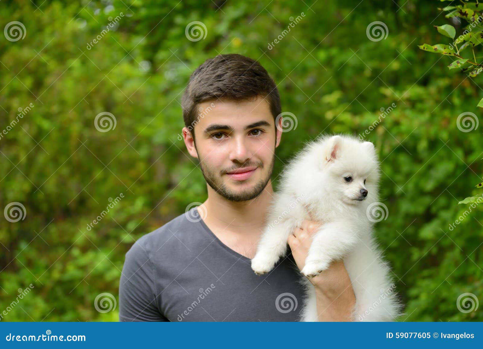 Young Man Holding German Spitz Puppy Stock Image - Image of furry ...